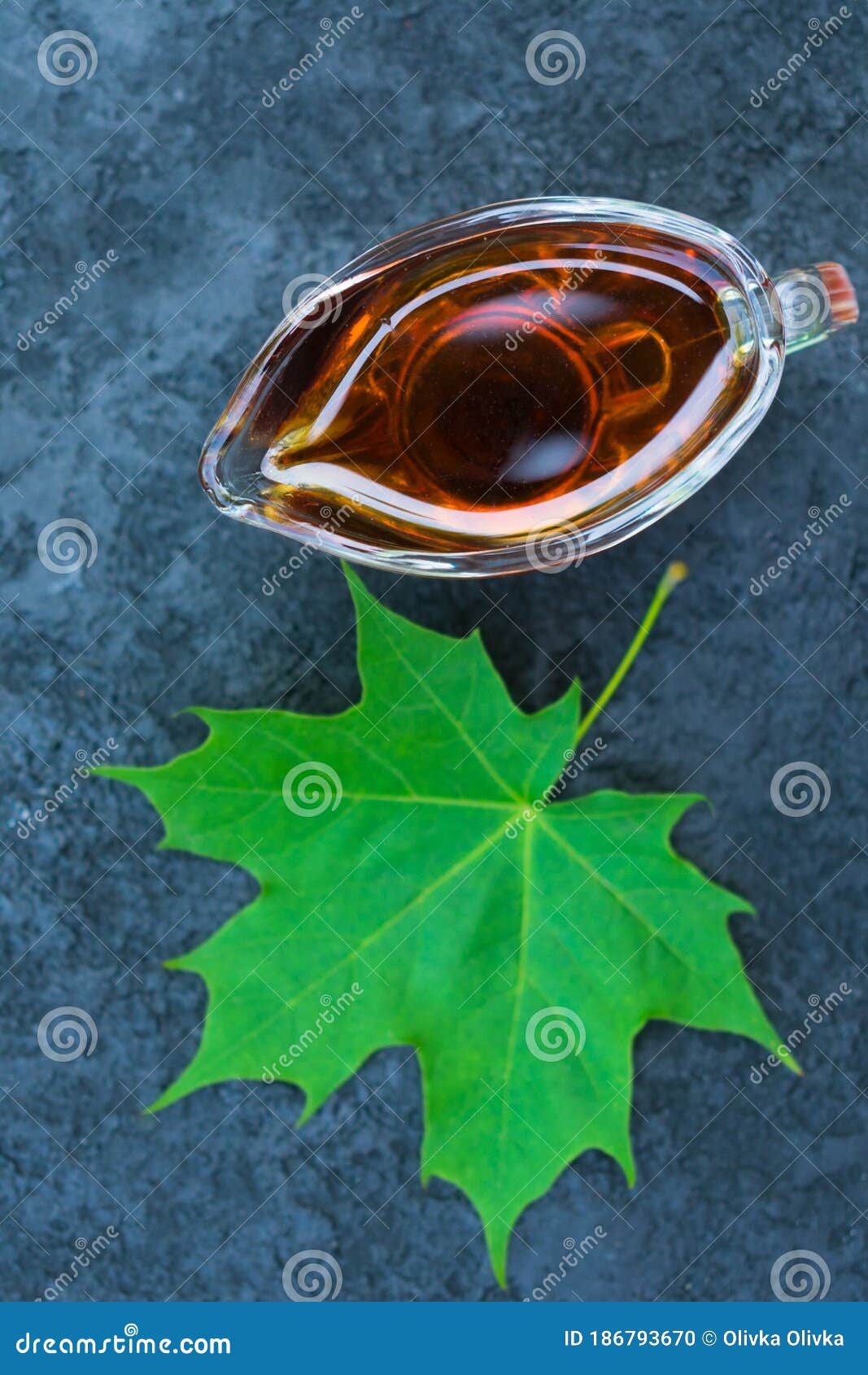 Maple Syrup and Maple Leaf on a Black Background. Top View. Stock Photo ...