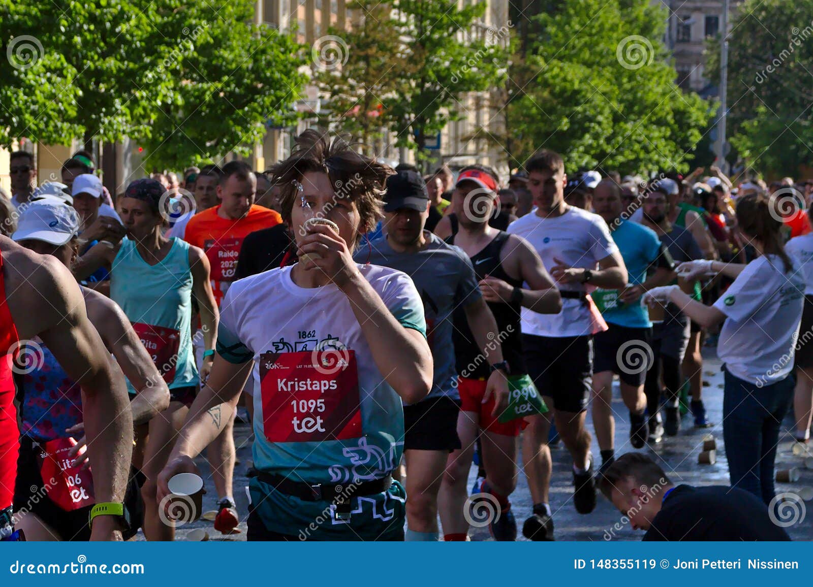 Riga, Latvia - May 19 2019: Marathon Runner Young Man Drinking Water ...