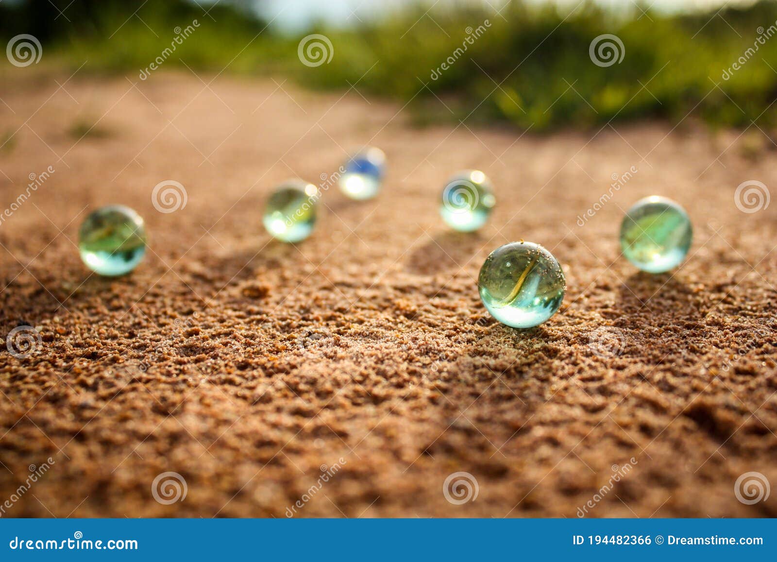 Marbles on the sandy floor stock photo. Image of reflections - 194482366