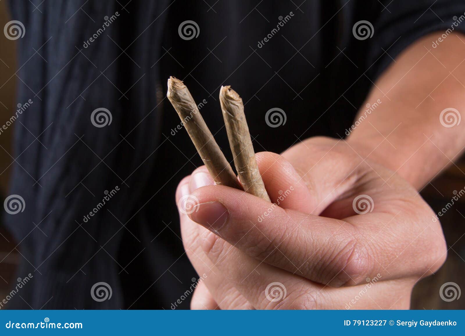 Marijuana Joints in the Mans Hand. Man Offering Drugs Stock Image ... Marijuana Joints in the Mans Hand. Man Offering Drugs Stock Image ...