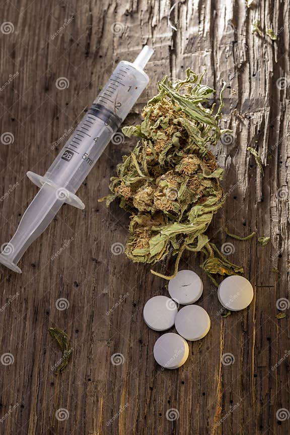 Marijuana and Syringe on a Background of Bog Oak 2019 Stock Photo ...