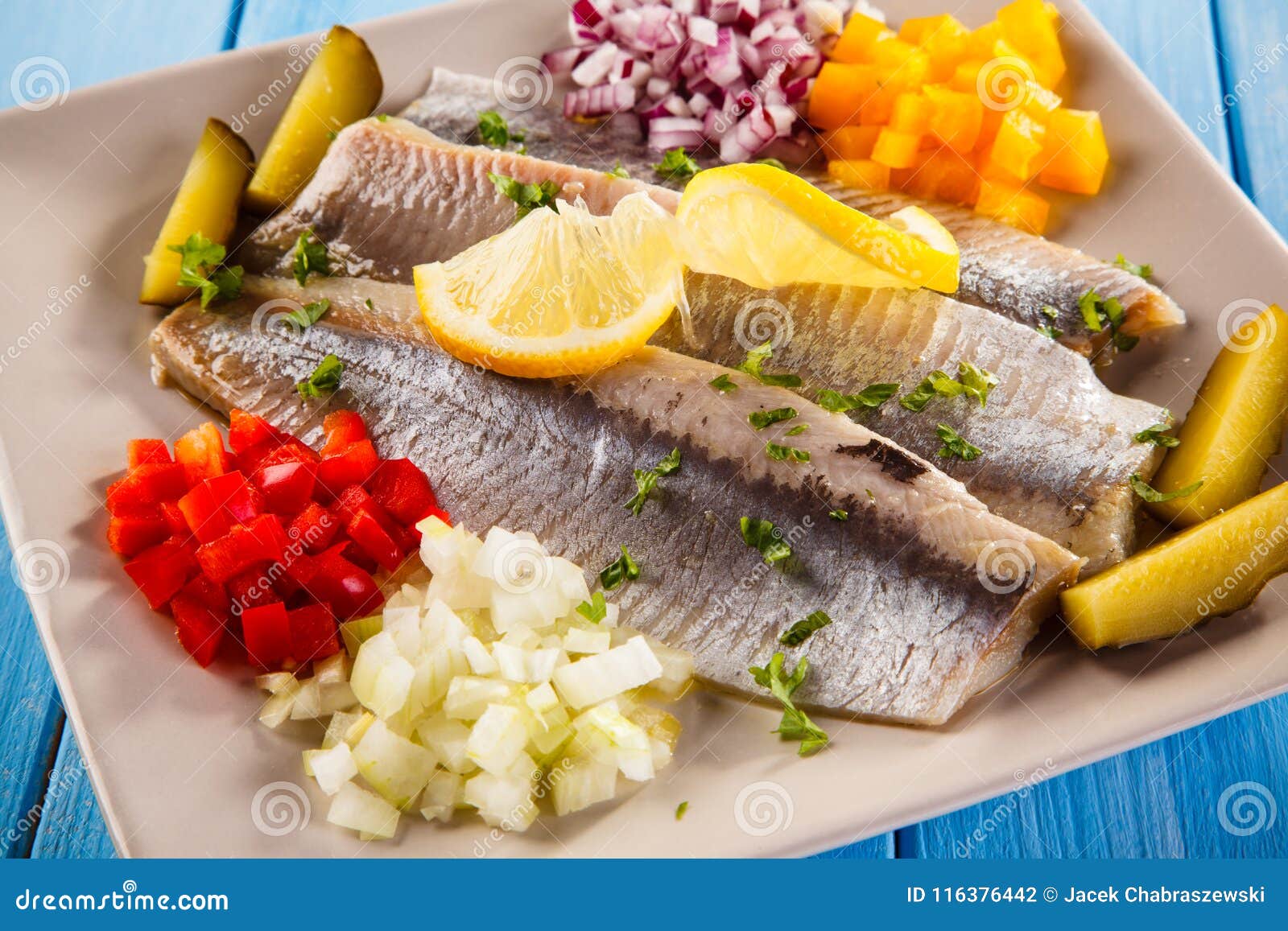 Marinated herring fillets stock photo. Image of garnish - 116376442
