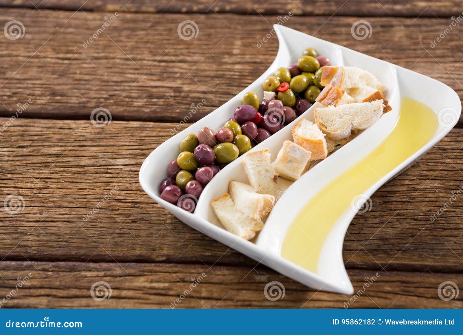 Marinated Olives, Bread Pieces and Olive Oil in Platter Stock Photo ...