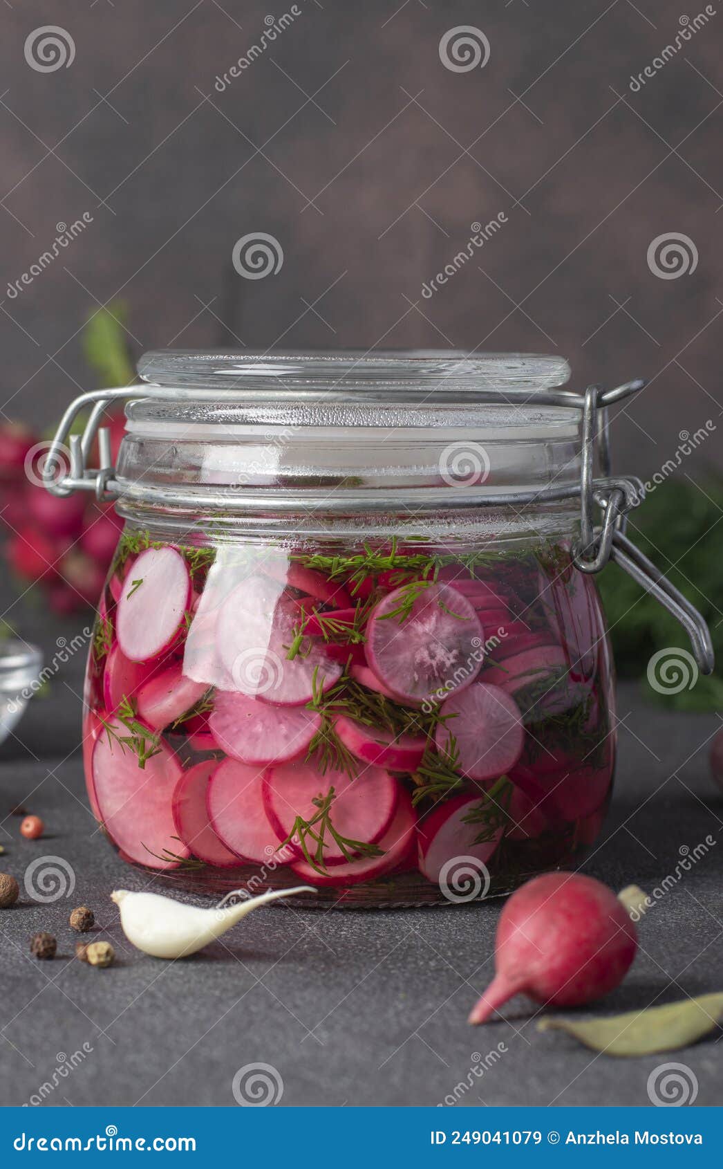 Marinated Radish with Dill and Garlic in Glass Jar on Brown Background ...