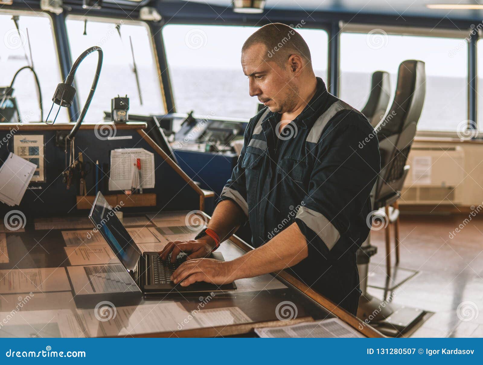 Marine Navigational Officer is Using Laptop or Notebook at Sea Stock ...