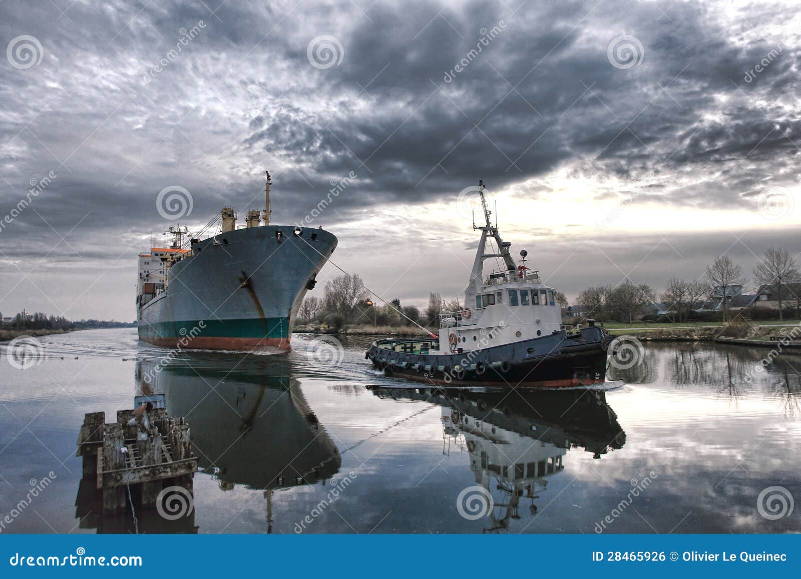 Maritime Tugboat Pulling a Cargo Ship on a Canal Stock Photo - Image of ...