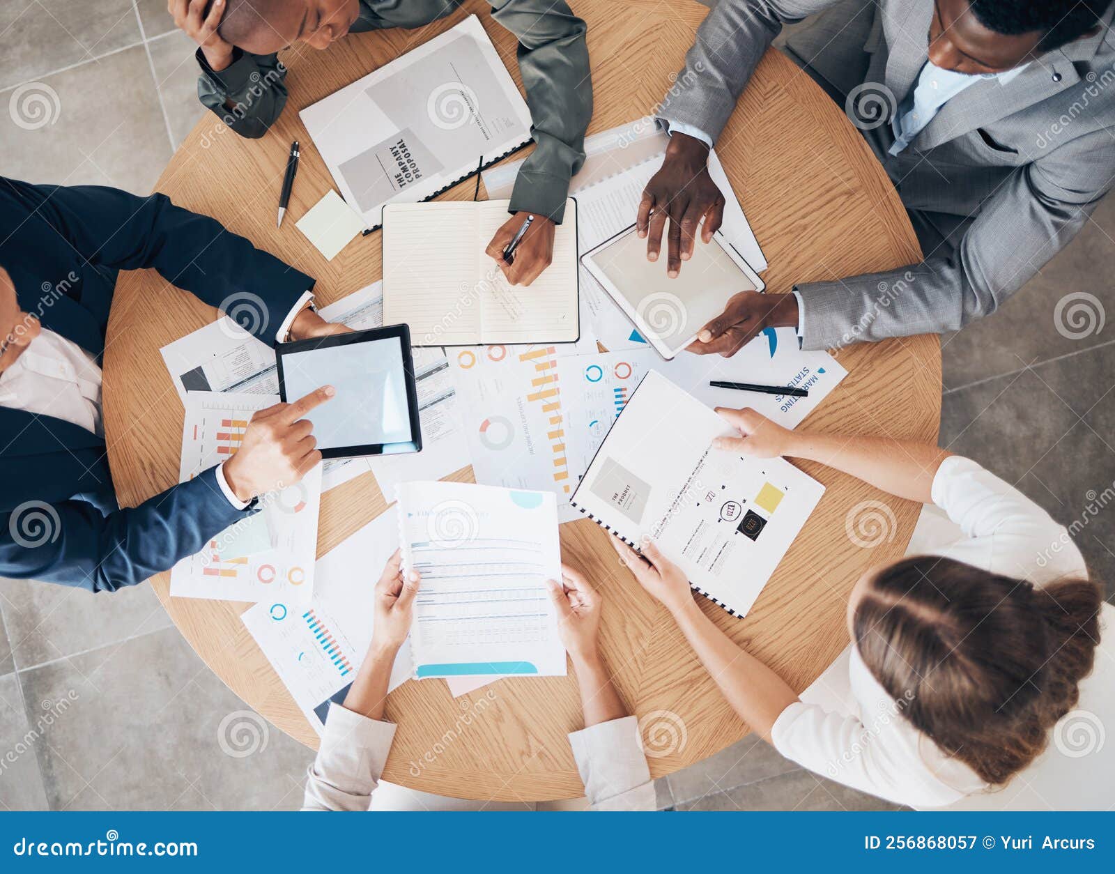 Marketing Team with Data Documents and Technology Working on a Project ...