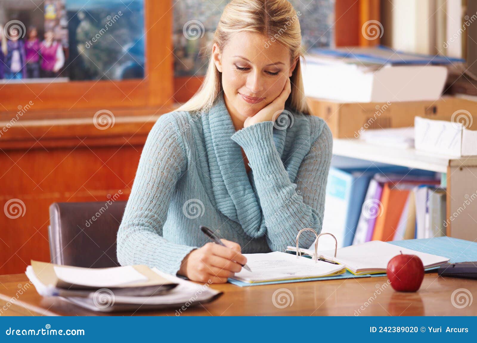 Marking Homework. a Young Teacher Marking Exam Papers in Her Office ...