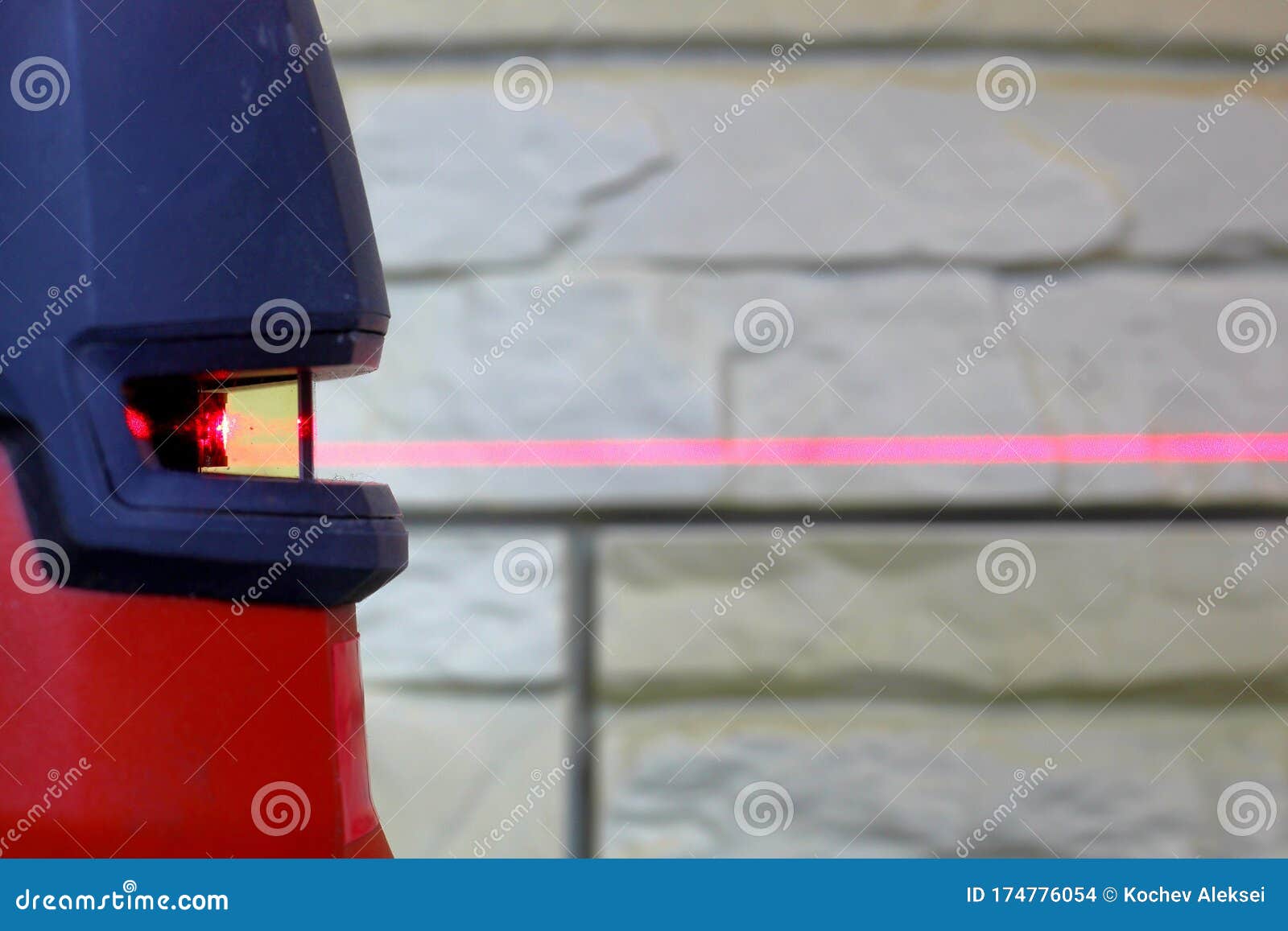 Marking a Wall Using a Laser Level. Red Beam on a Stone Wall. Repair ...