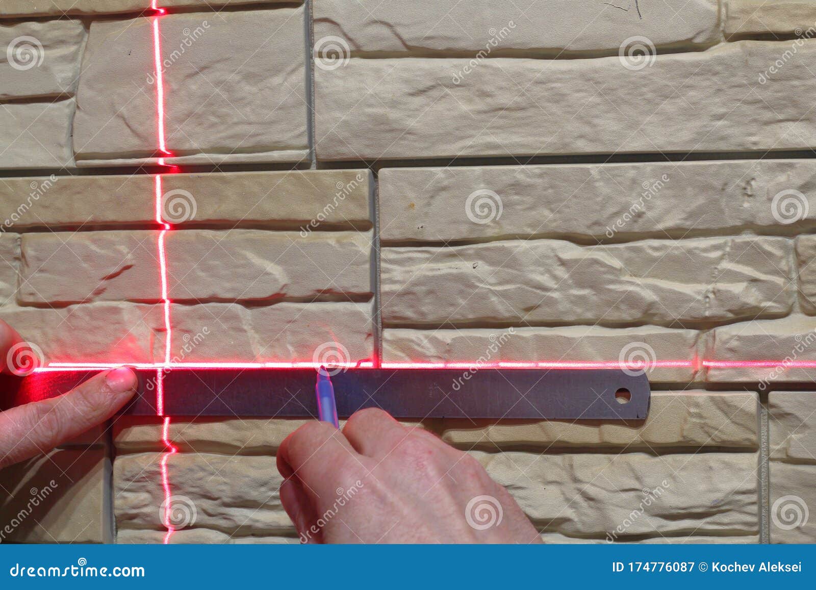 Marking a Wall Using a Laser Level. Red Beam on a Stone Wall. Repair ...