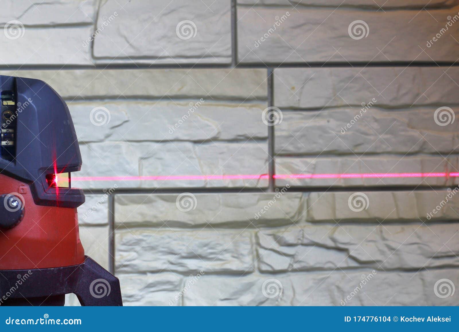 Marking a Wall Using a Laser Level. Red Beam on a Stone Wall. Repair ...