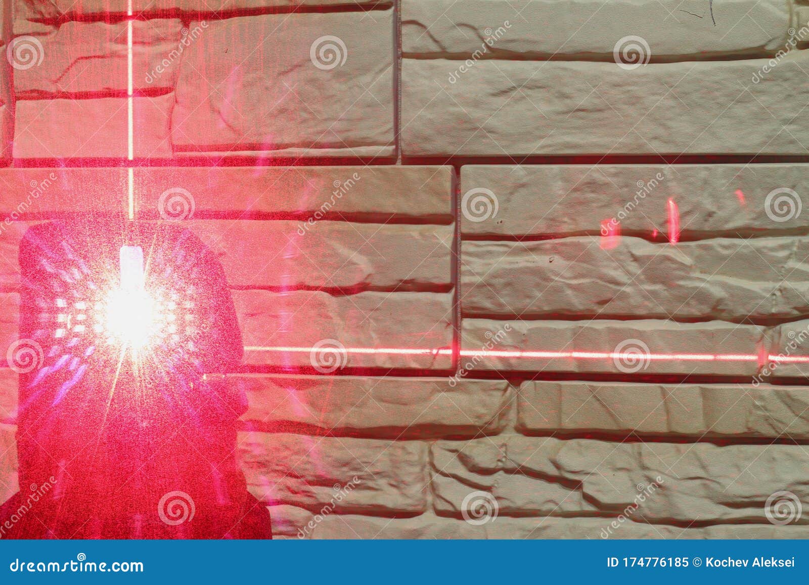 Marking a Wall Using a Laser Level. Red Beam on a Stone Wall. Repair ...