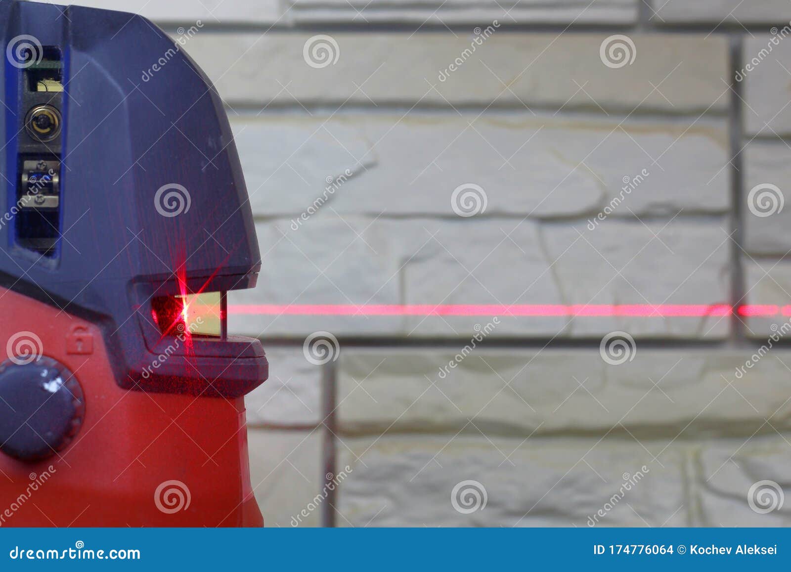 Marking a Wall Using a Laser Level. Red Beam on a Stone Wall. Repair ...