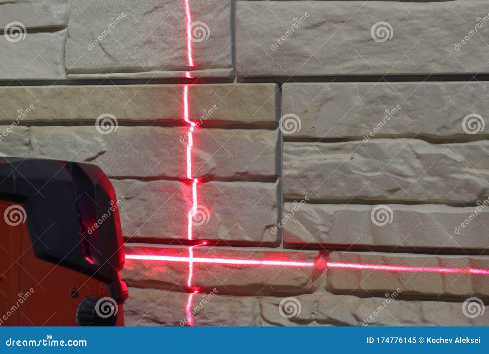 Marking a Wall Using a Laser Level. Red Beam on a Stone Wall. Repair ...