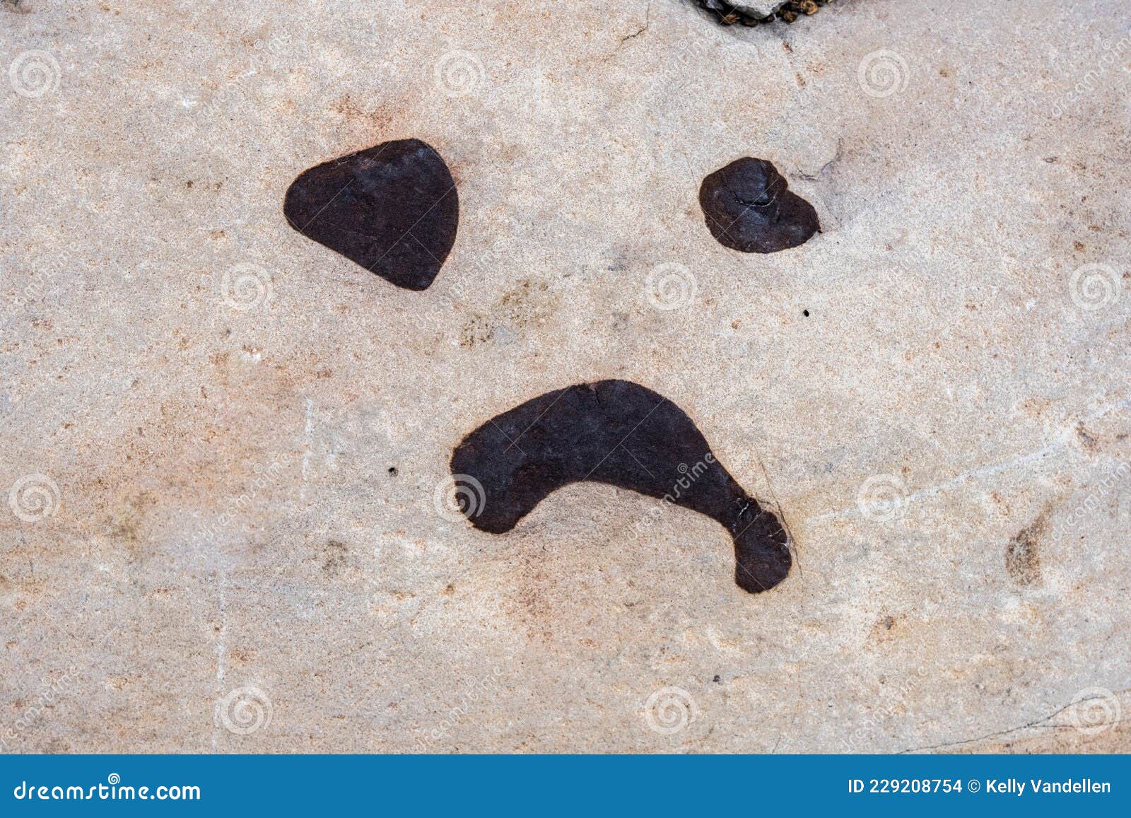 Markings on Stone in the Shape of a Sad Face Stock Photo - Image of ...