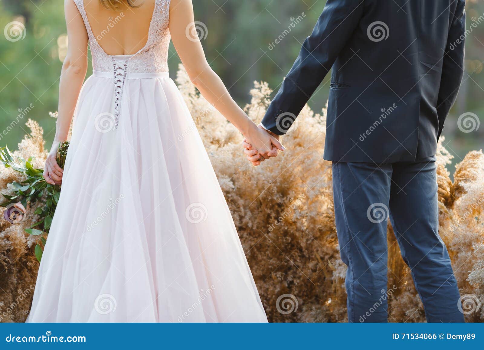 Married Couple Standing Back and Holding Hands Stock Photo - Image of ...
