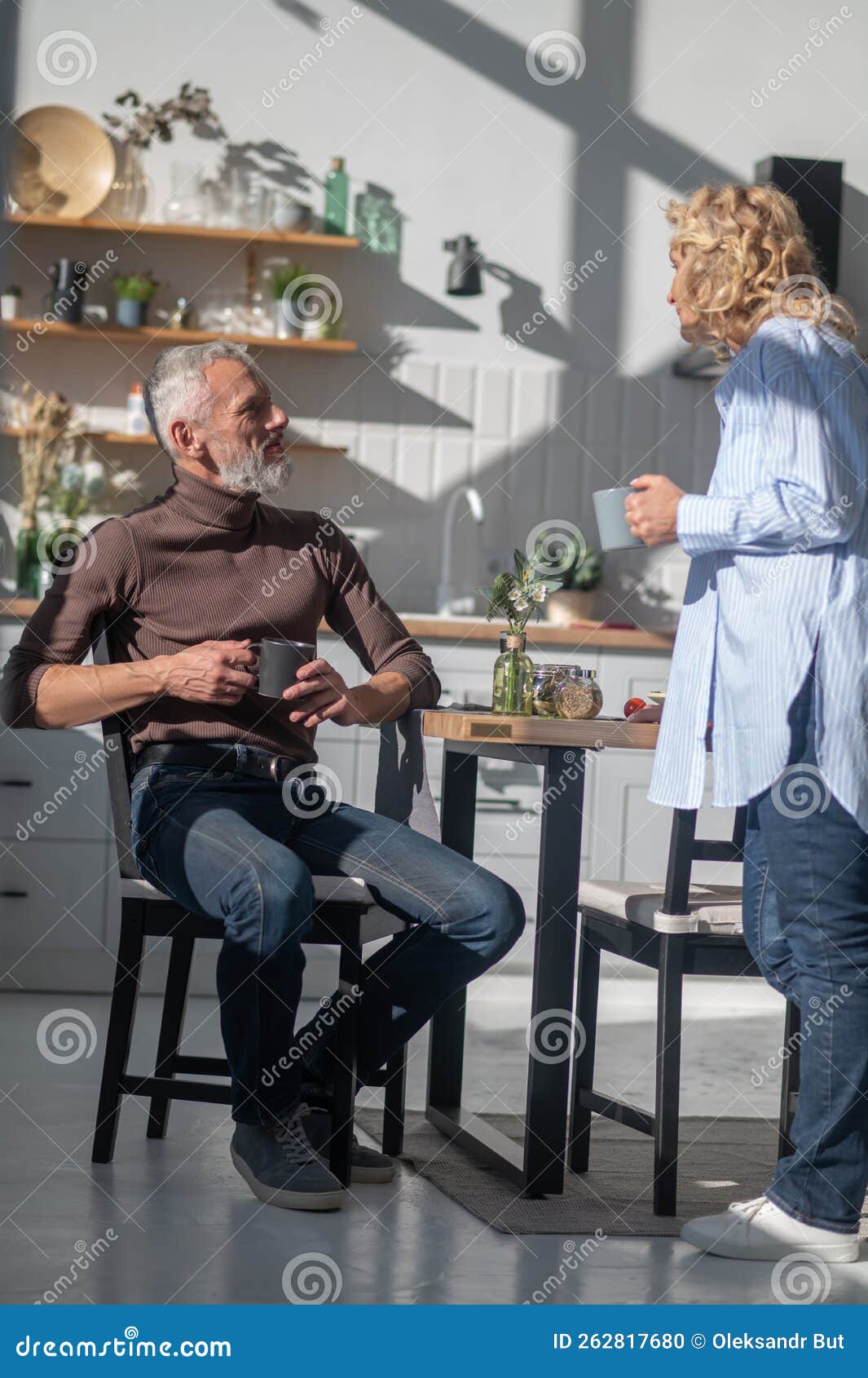 A Married Couple Talking in the Kitchen Stock Photo - Image of ...