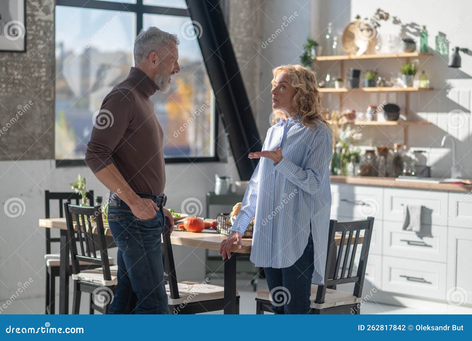 A Married Couple Talking in the Kitchen Stock Photo - Image of talk ...