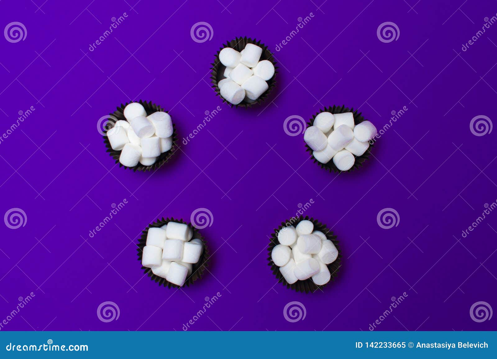 Marshmallows in the Forms for Cakes on a Purple Background, Five Pieces ...