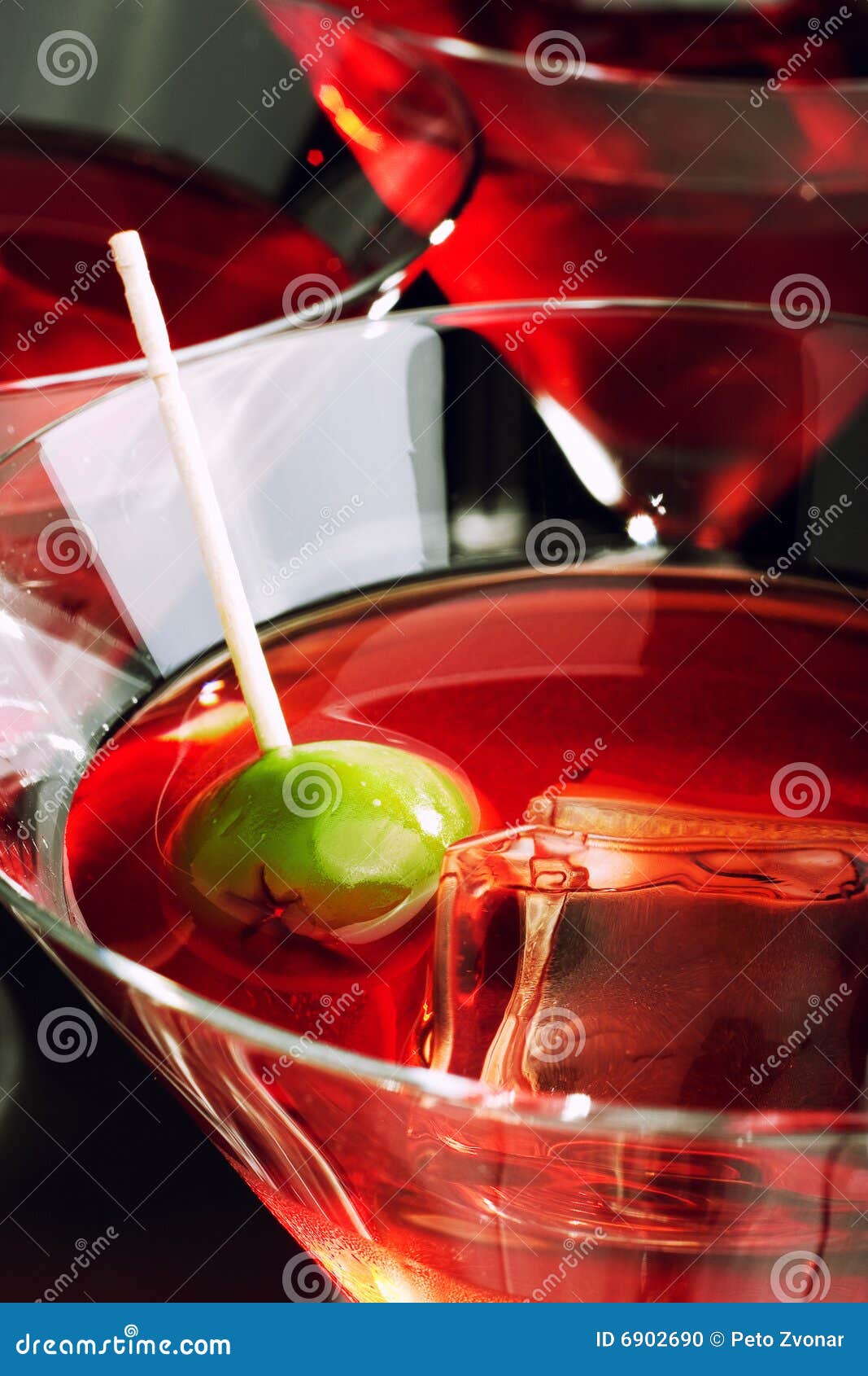 Martini Glass with Olive and Ice Cube Stock Photo - Image of party ...