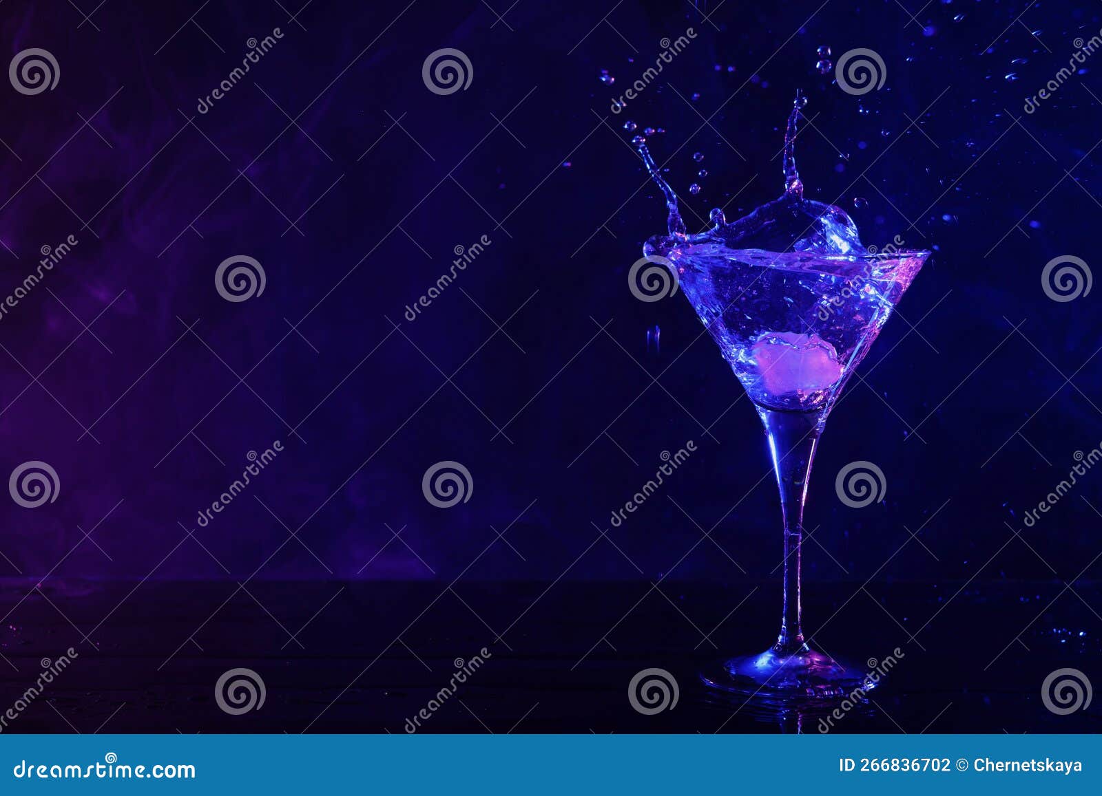 Martini Splashing Out of Glass in Neon Lights, Space for Text Stock ...