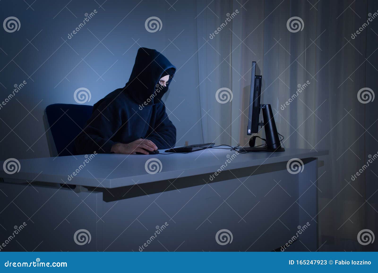 Masked Hacker in Front at Computer into Dark Room. Internet Security ...