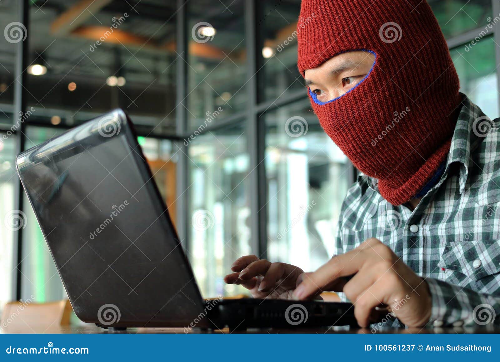 Masked Hacker Wearing a Balaclava Looking a Laptop and Stealing ...