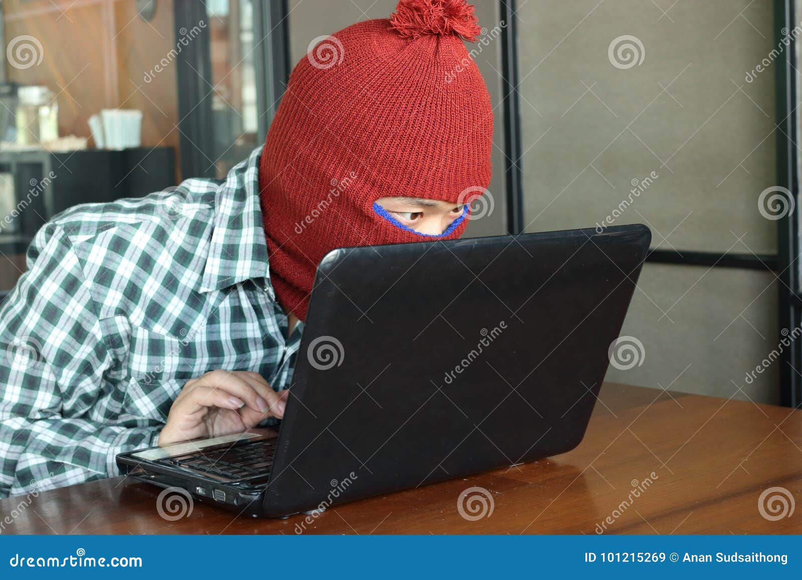 Masked Hacker Wearing a Balaclava Stealing Important Information Data ...