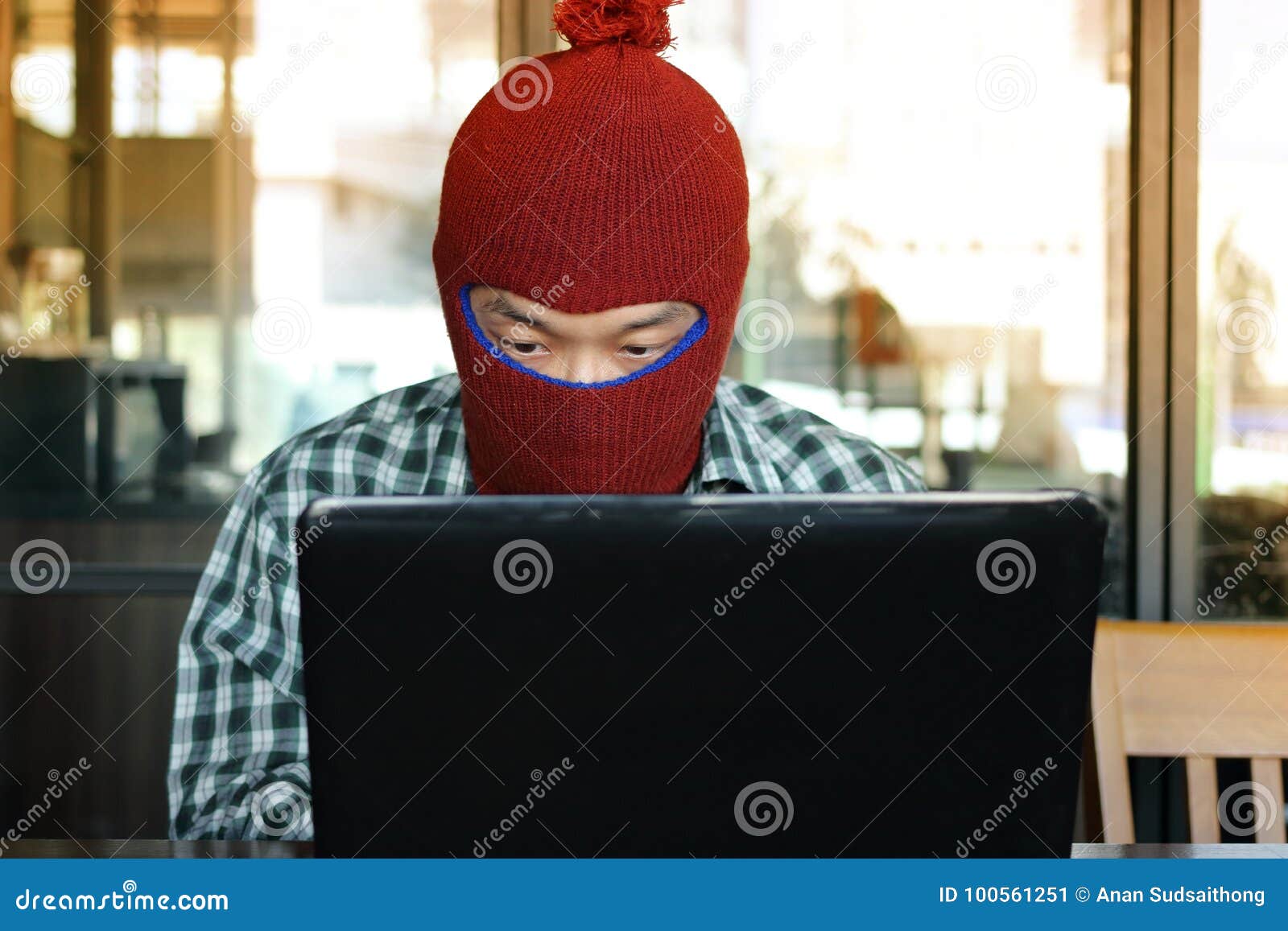 Masked Hacker Wearing a Balaclava Stealing Information Data with Laptop ...