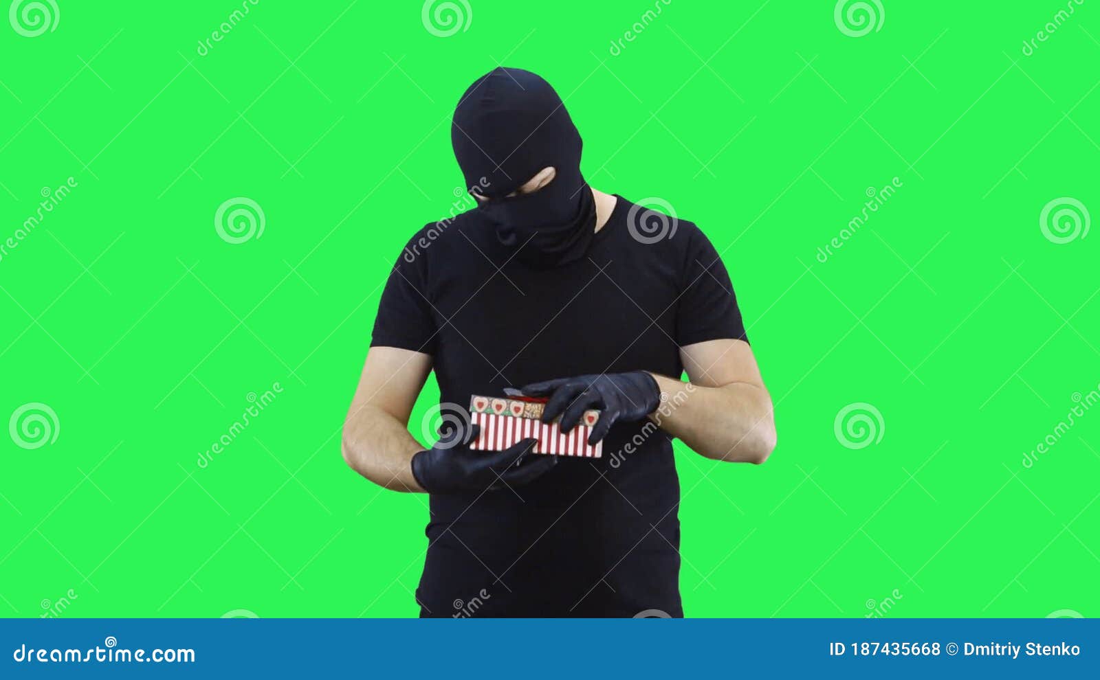 The Masked Man Slowly Opens the Gift Box.Balaclava.Green Screen ...