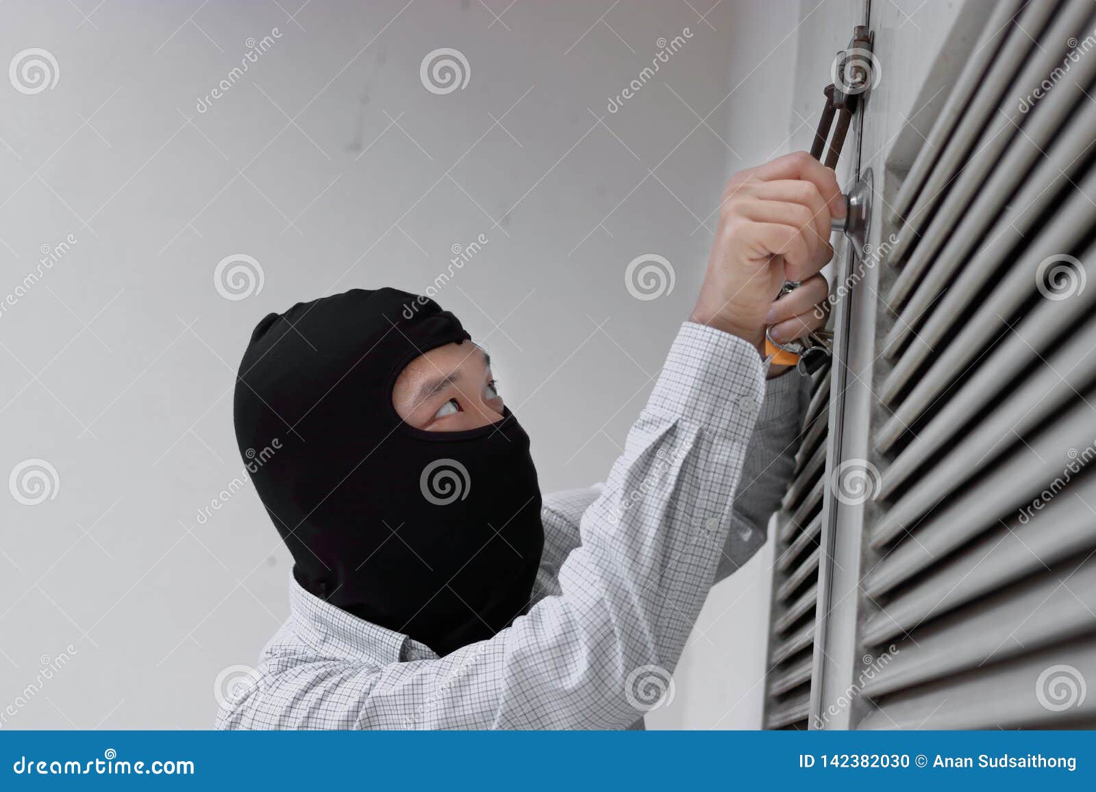 The Masked Robber Breaks Removing The Surveillance Camera Mount Stock