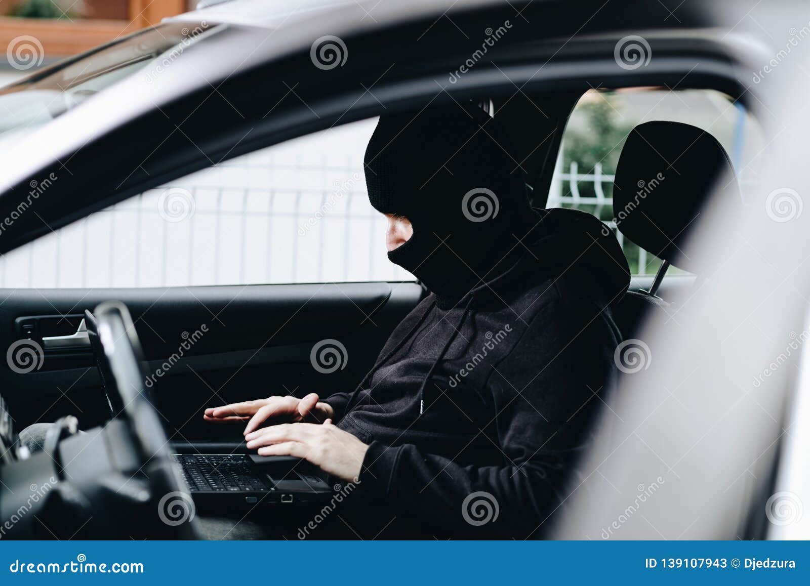 Masked Thief Hacker in a Balaclava Disarming Car Security Systems Stock ...