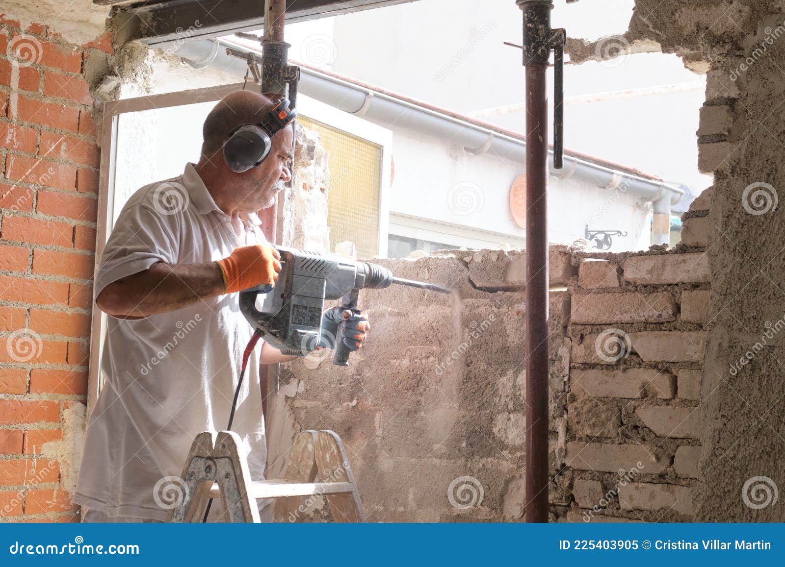 Mason Breaking a House Wall with a Demolition Hammer. Stock Image ...
