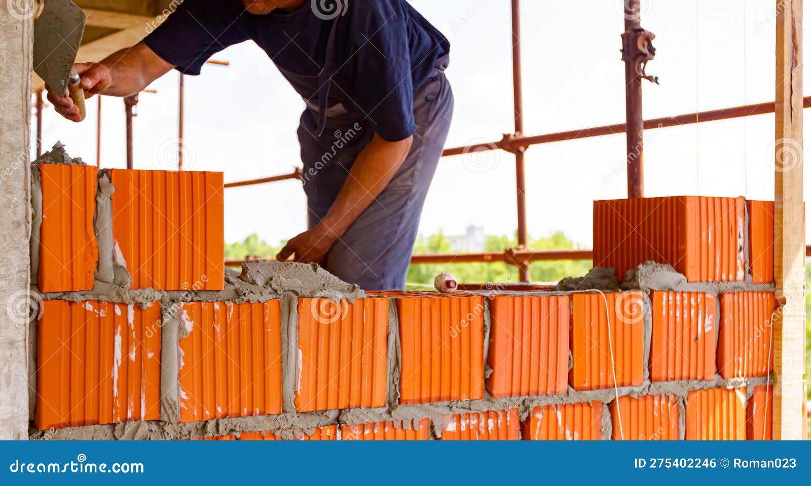 Worker is Building Wall with Red Blocks and Mortar Stock Photo - Image ...