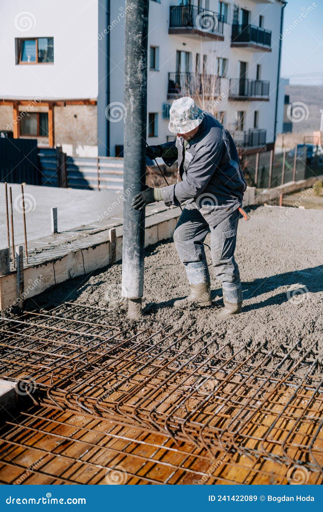 Mason Building and Worker Using a Automatic Cement Pump and Levelling a ...