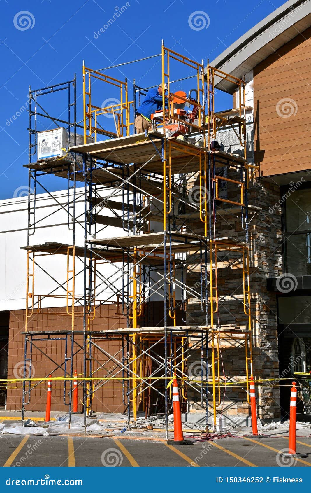 Mason Cutting a Brick on Top of a Scaffolding Editorial Photography ...