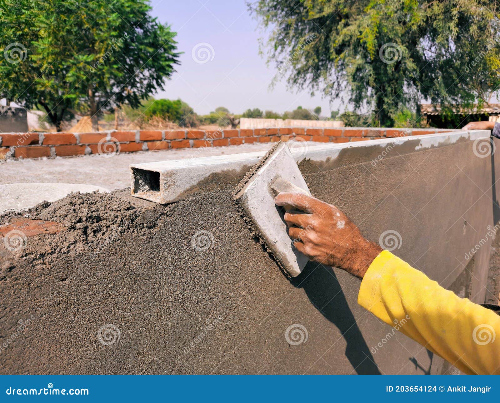 Mason Finishing Cement Plaster on Wall and Smoothing it Manually Stock ...