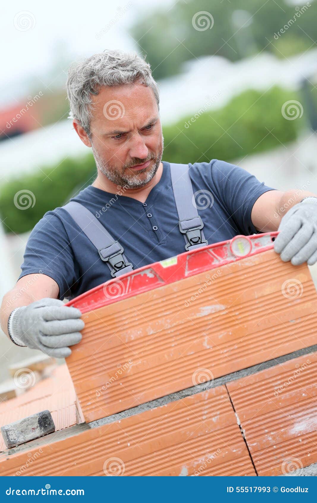 Mason Laying Bricks and Measuring Stock Image - Image of outdoors ...