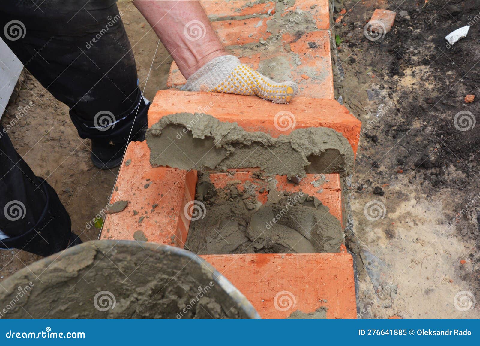 Mason Laying House Brick Wall with Mortar on the Side of the Brick ...