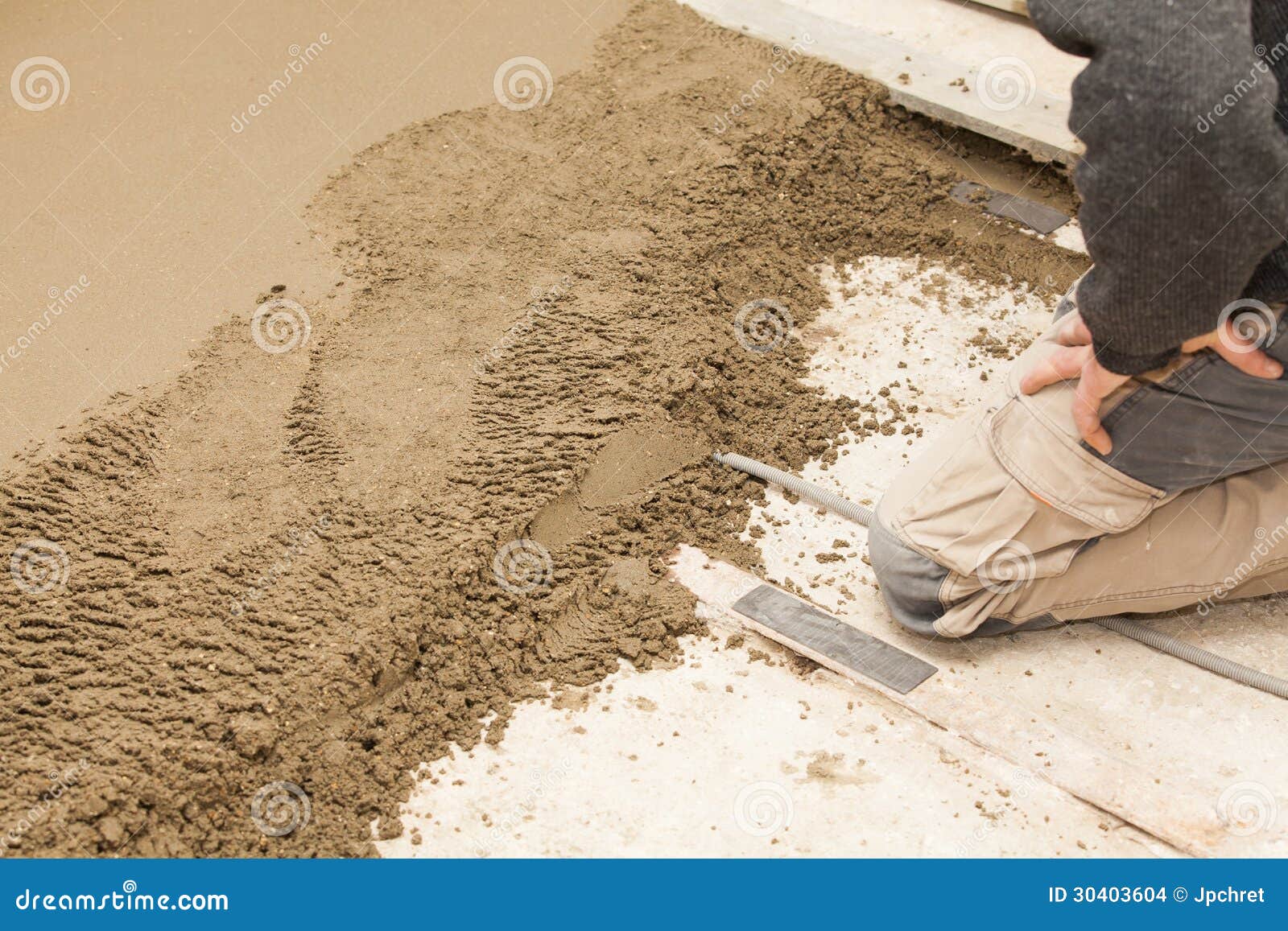Mason Leveling Concrete With Spreading Poured Concrete Royalty-Free ...