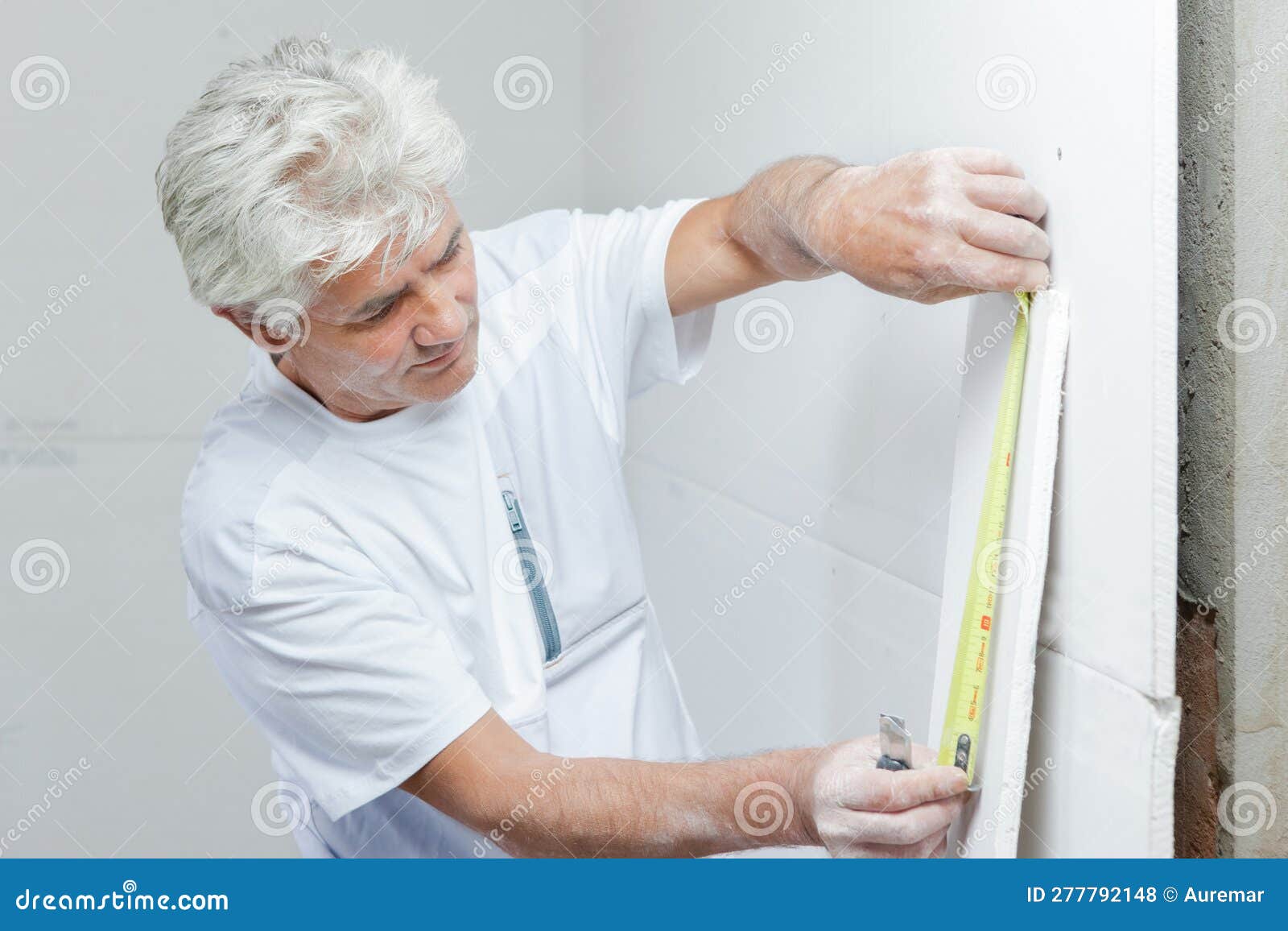 Mason measuring a wall stock photo. Image of electrical - 277792148