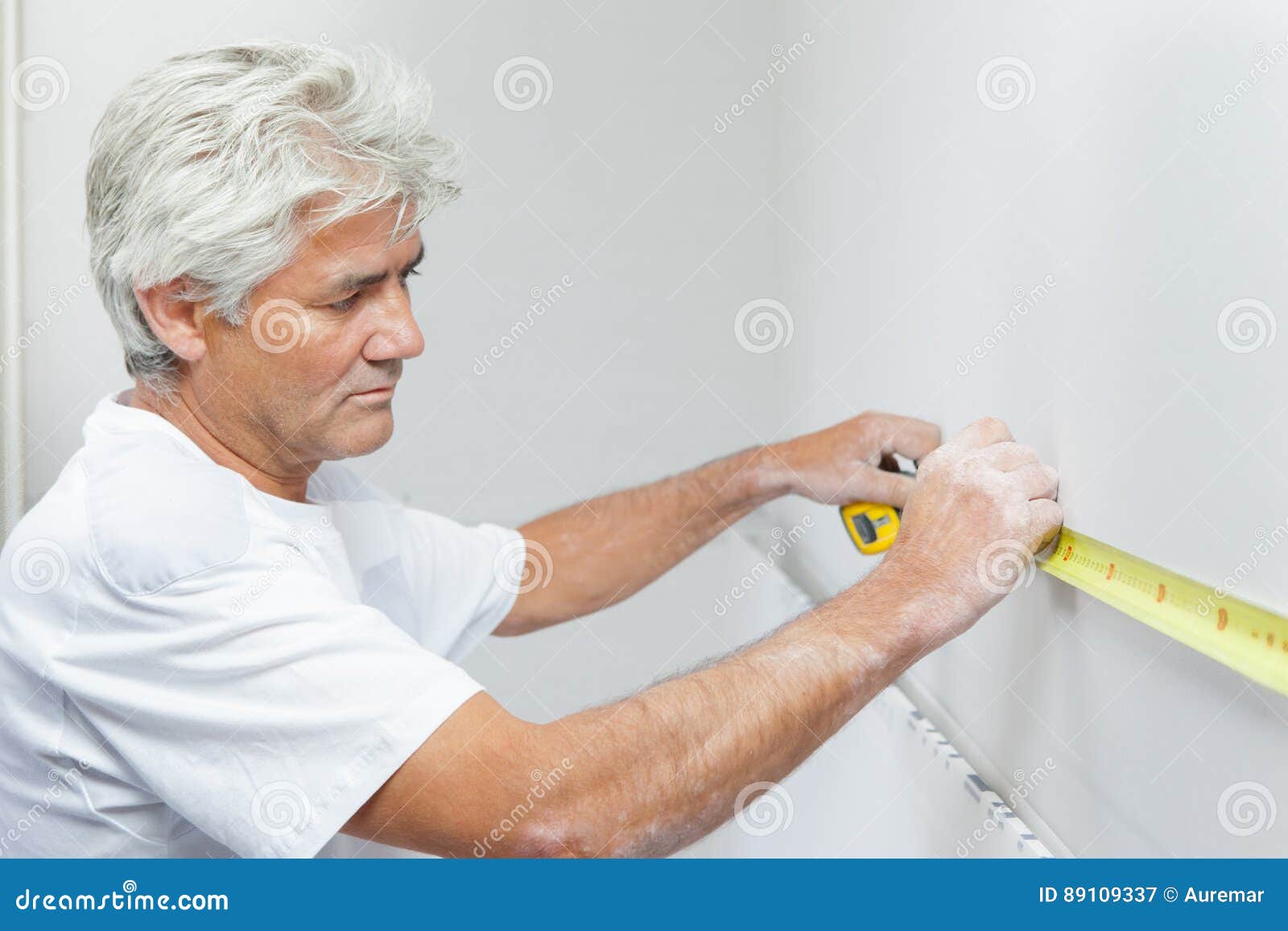 Mason measuring white wall stock image. Image of renovation - 89109337