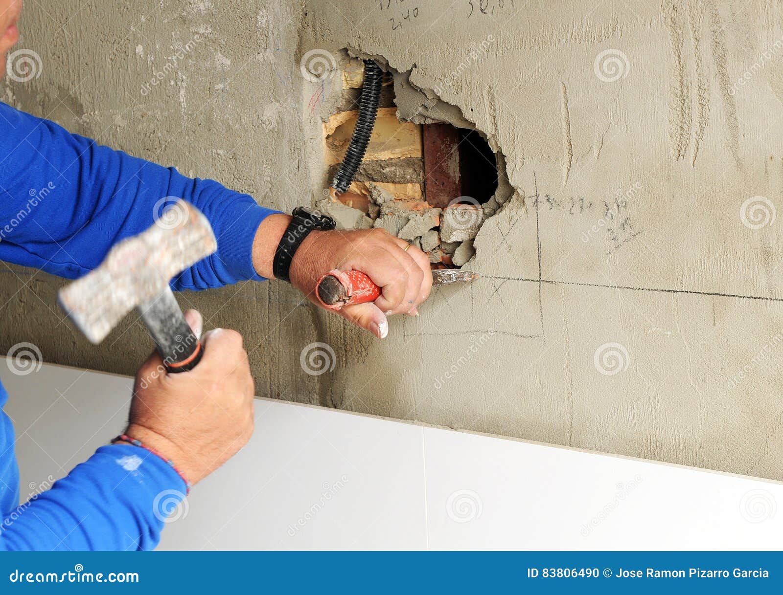 Mason Preparing the Hole in the Wall To Place a Box Electrical Outlets ...