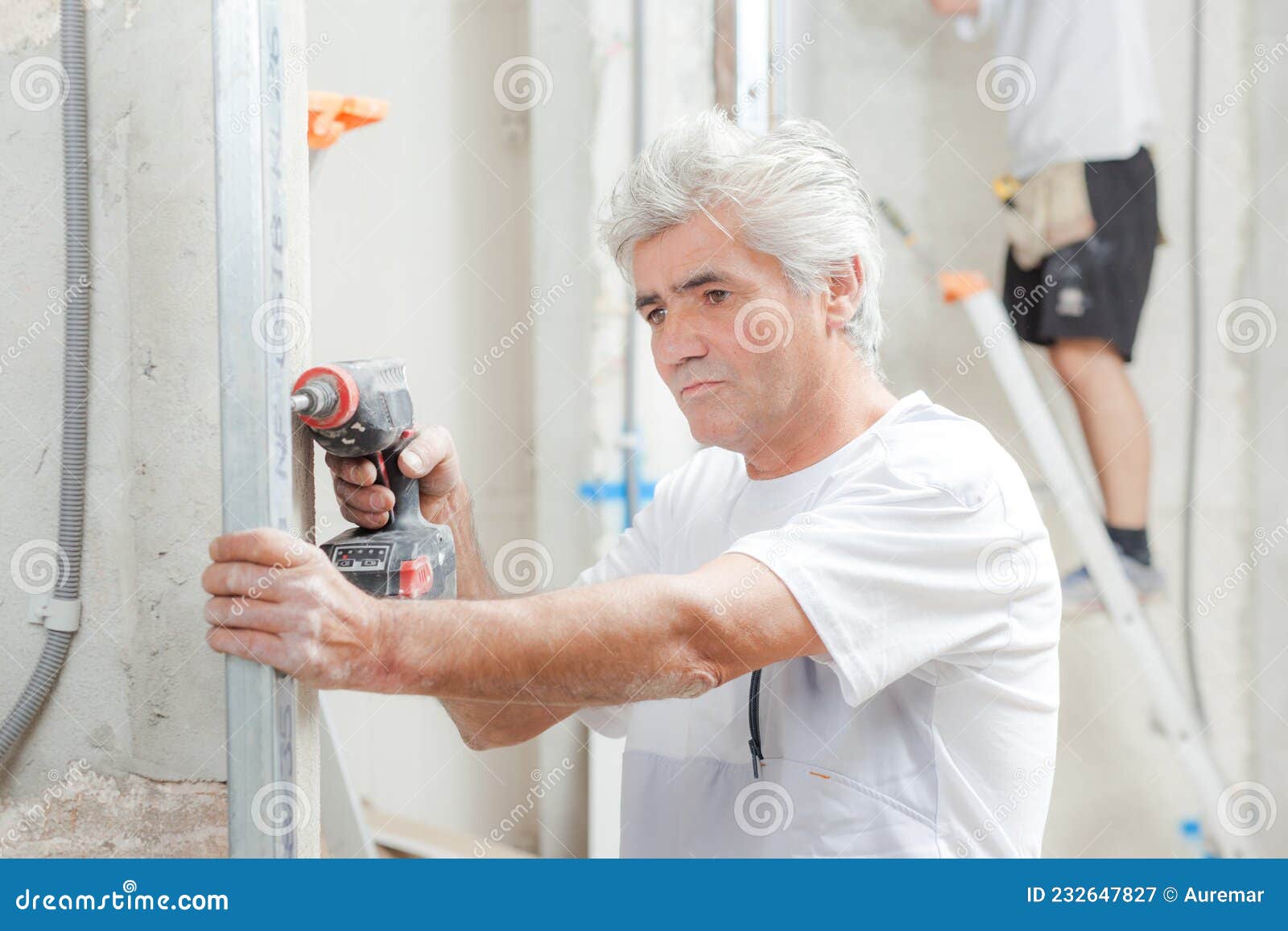 Mason using a drill stock image. Image of professional - 232647827