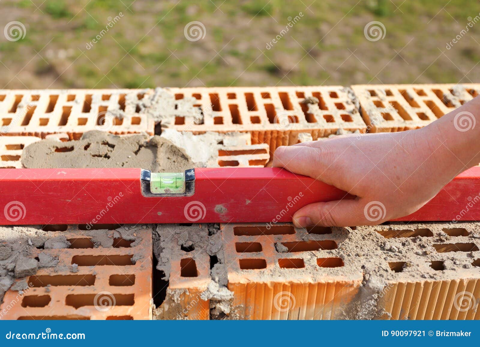 Mason Worker Measuring with Professional Level the Bricks Under ...
