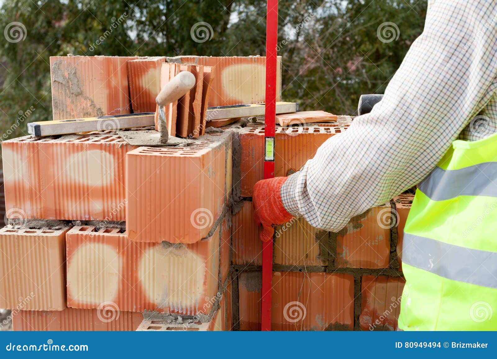 Mason Worker Measuring with Professional Level the Bricks Under ...