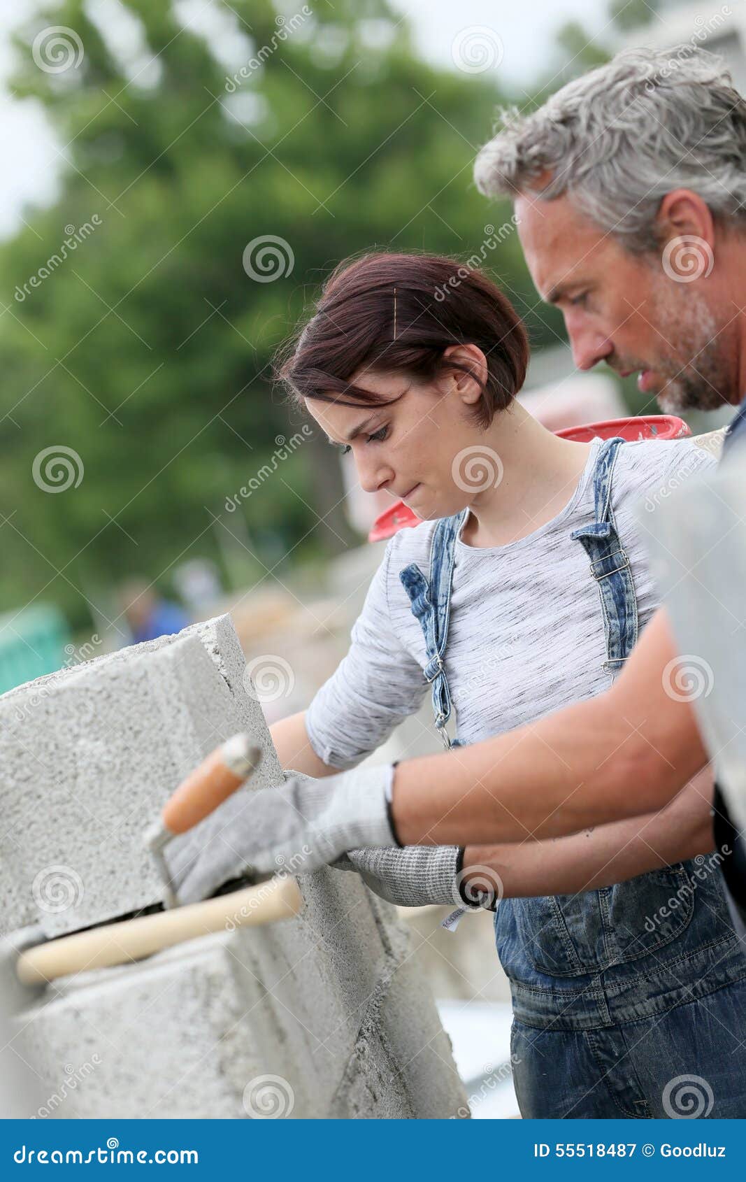 Mason with Young Woman Trainee at Work Stock Image - Image of builder ...