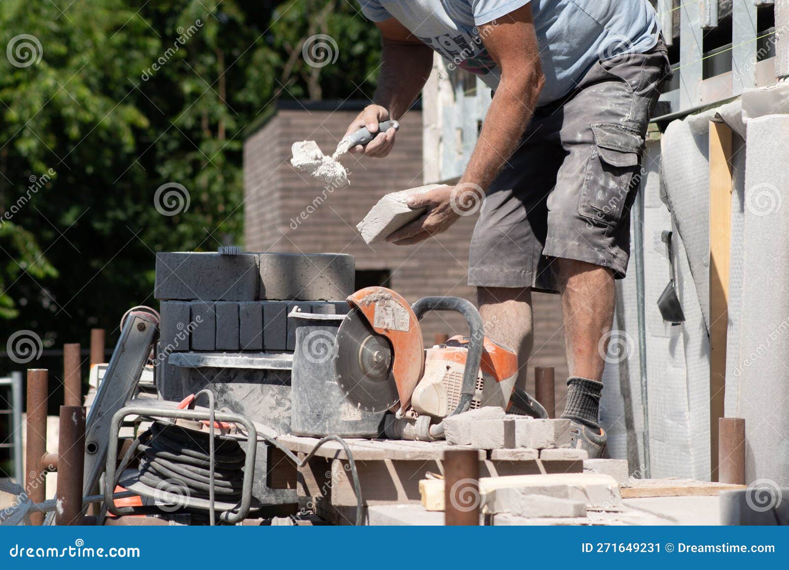 Masonry Worker the Bricklayer Makes the Facade of the House from Gray ...