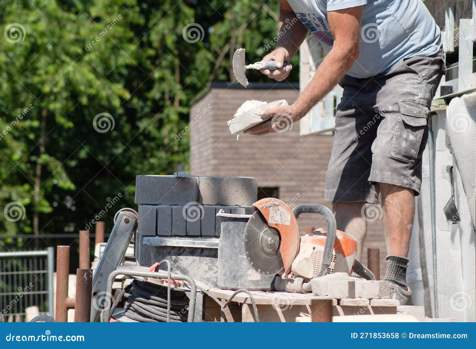 Masonry Worker the Bricklayer Makes the Facade of the House from Gray ...