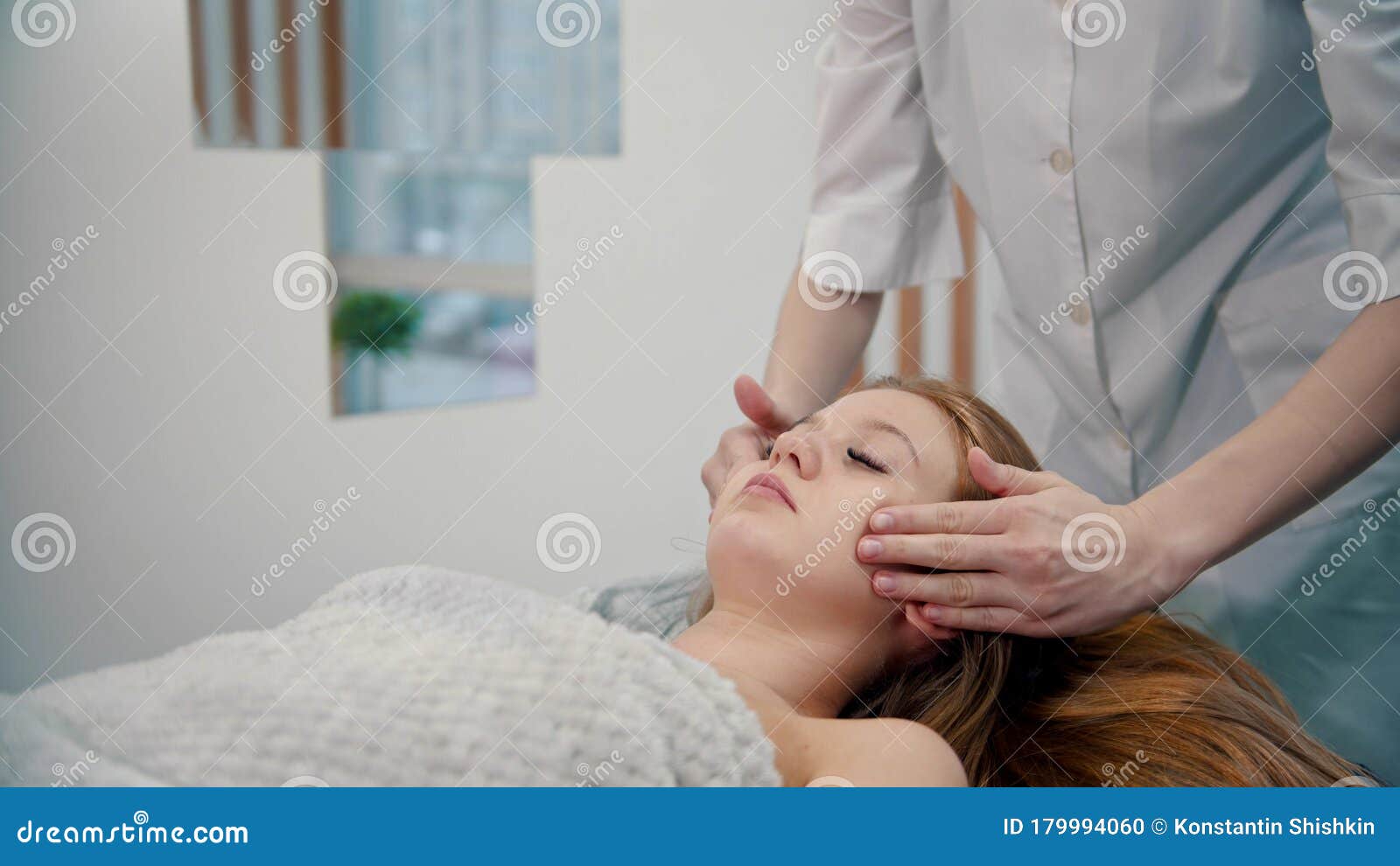 Massage - a Masseuse is Massaging Her Clients Cheeks Stock Photo ...